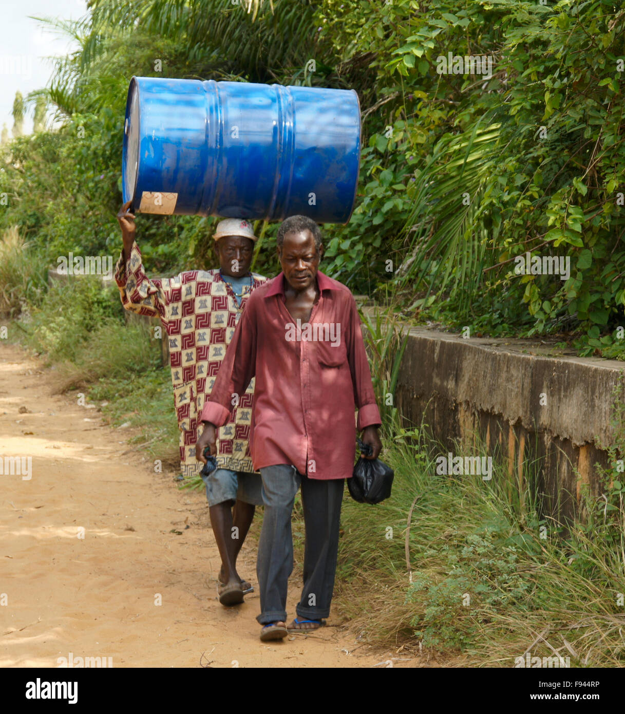 Man carrying barrel home from market, Ouidah, Benin Stock Photo - Alamy
