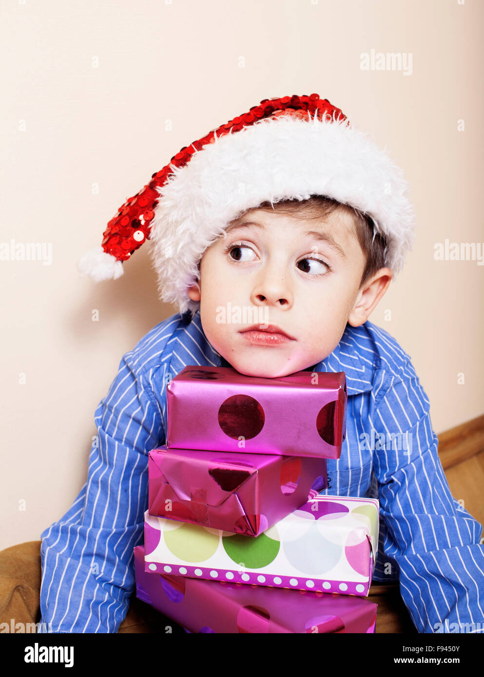 little cute boy with Christmas gifts at home. close up emotional face ...
