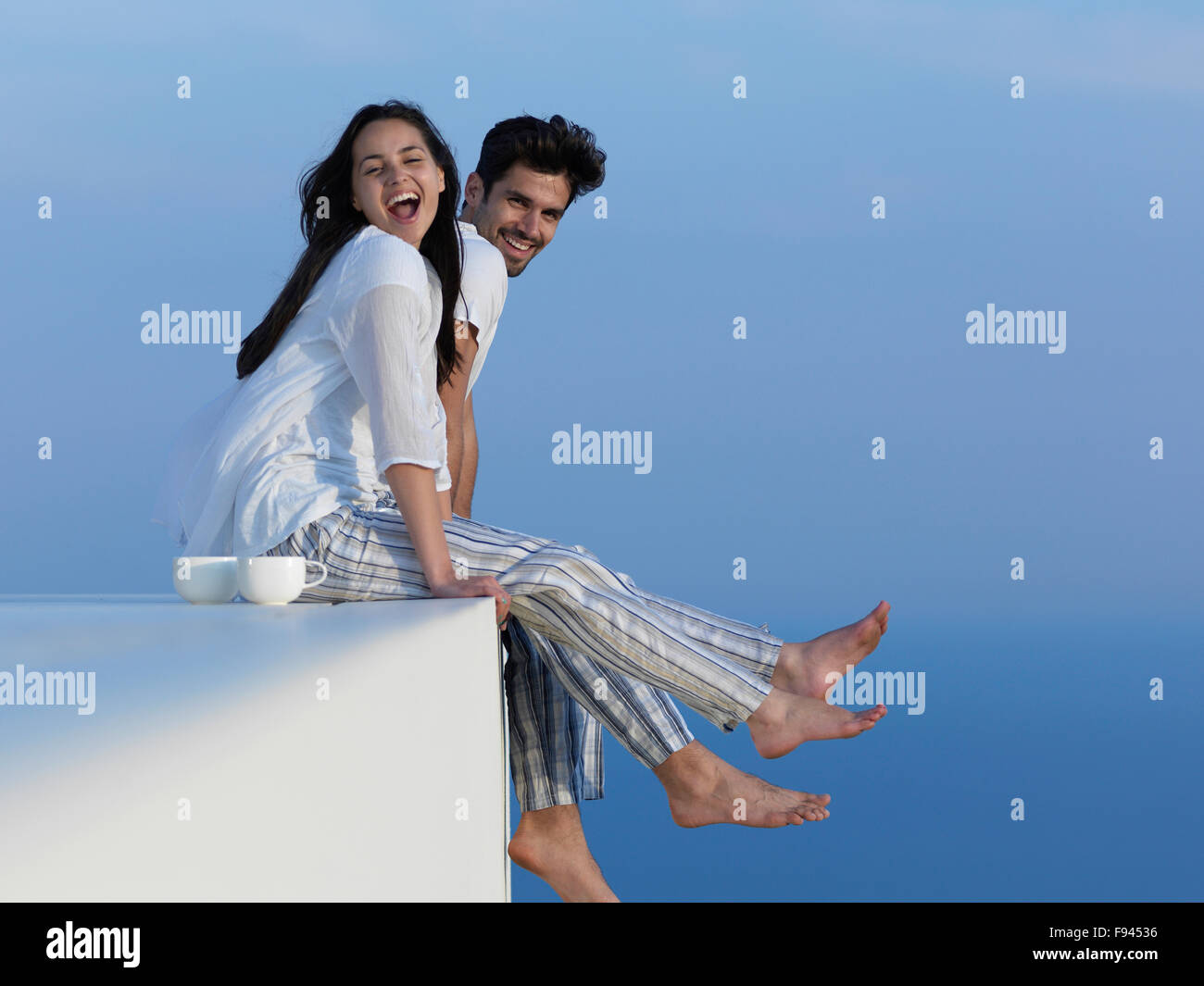 happy young romantic couple have fun relax smile at modern home outdoor ...