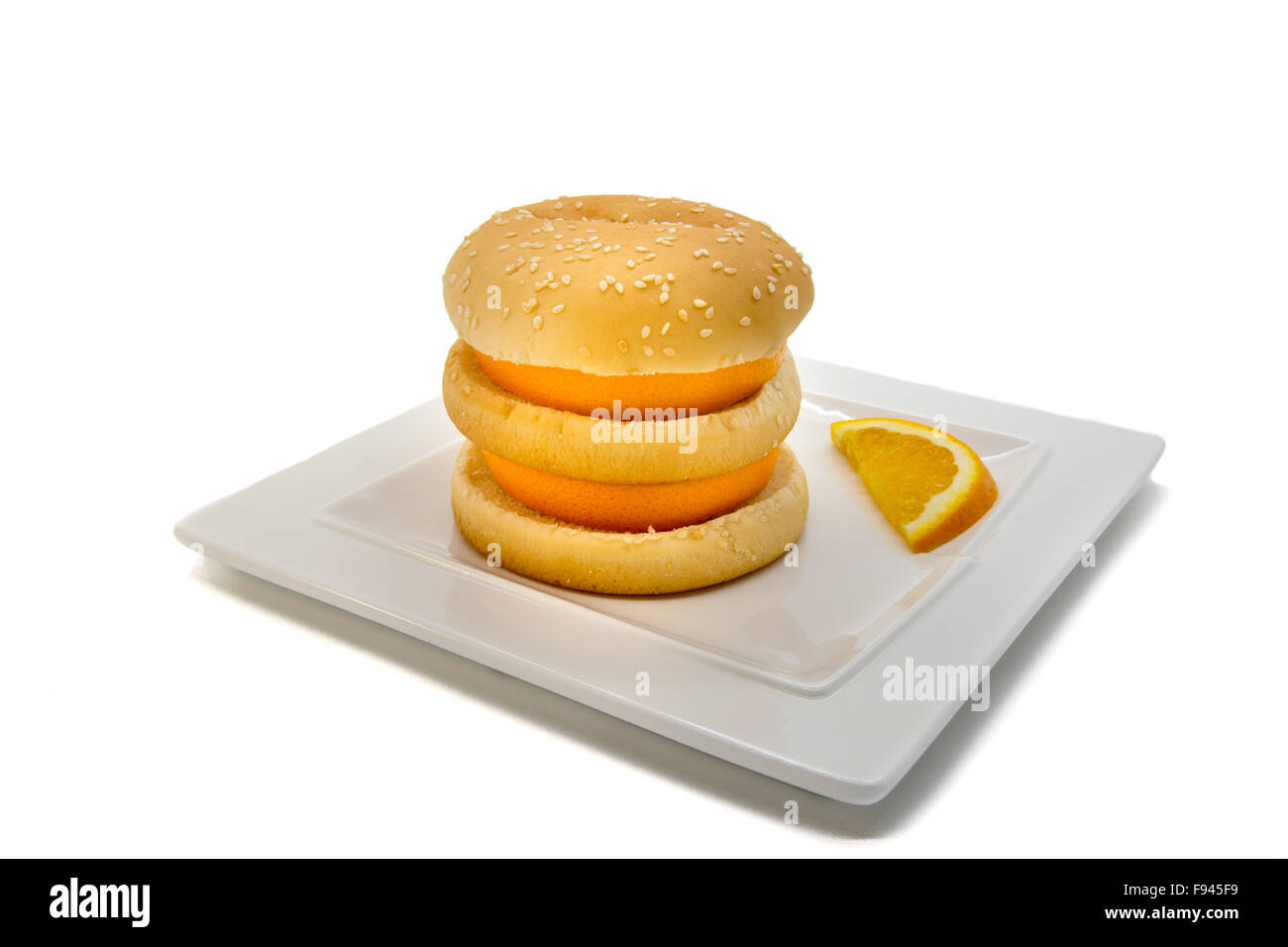 Burger with oranges on a white plate and background Stock Photo - Alamy