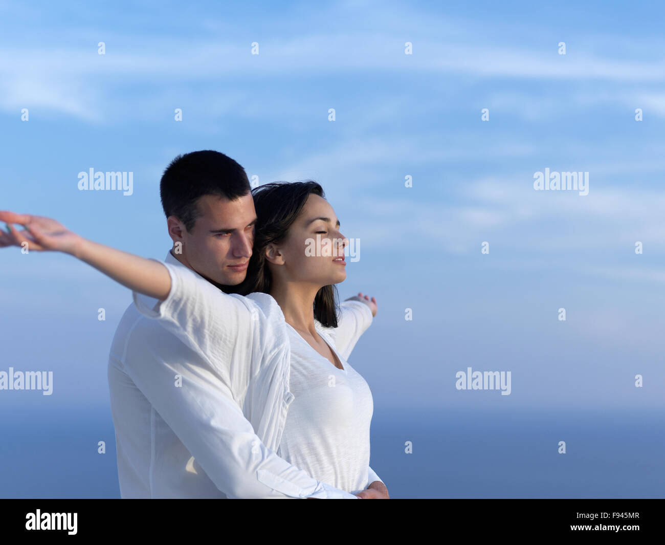 happy young romantic couple have fun relax smile at modern home outdoor ...