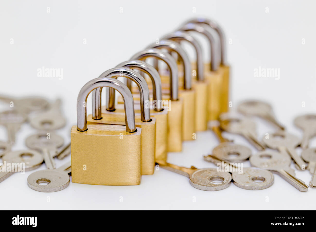 Several locks in a row with keys on white background Stock Photo - Alamy