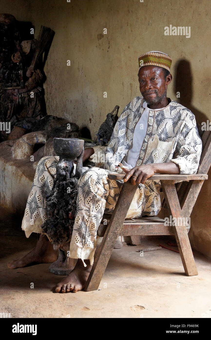 Vodun (voodoo) high priest (hounon) with fetishes in shrine to the ...