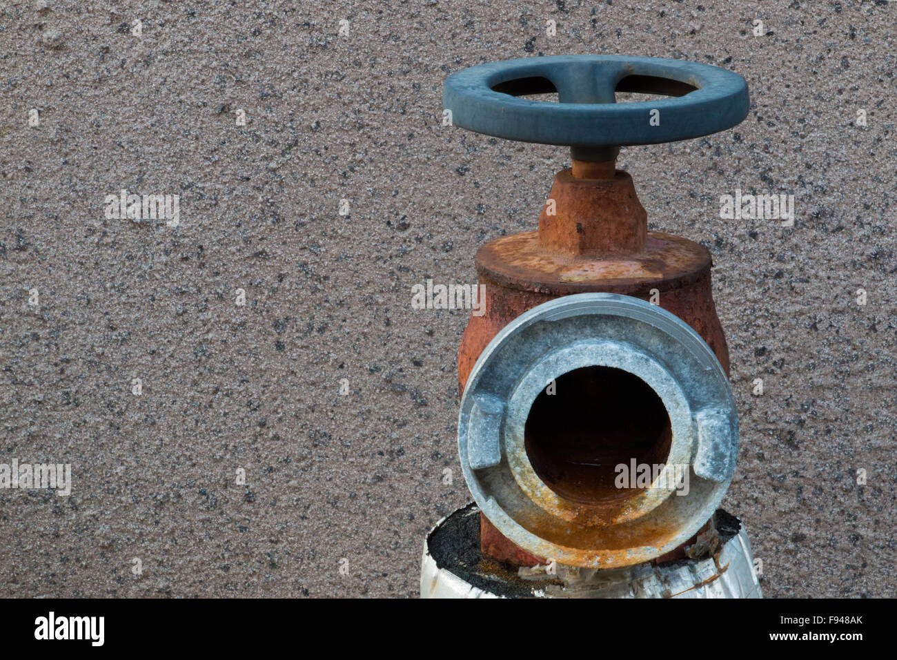 Old rusty valve in front of wall Stock Photo - Alamy