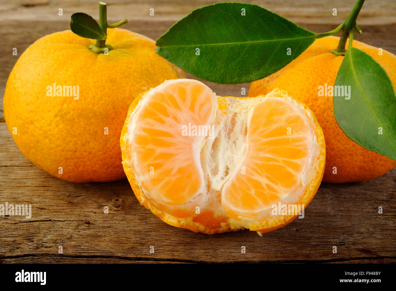Ripe mandarin fruit on rustic wooden background Stock Photo - Alamy