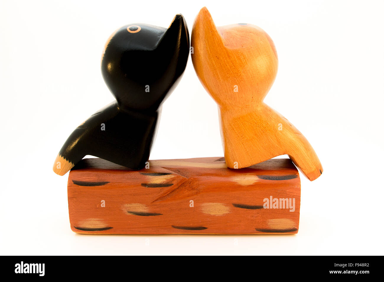 Wooden cats sitting back to back Stock Photo - Alamy