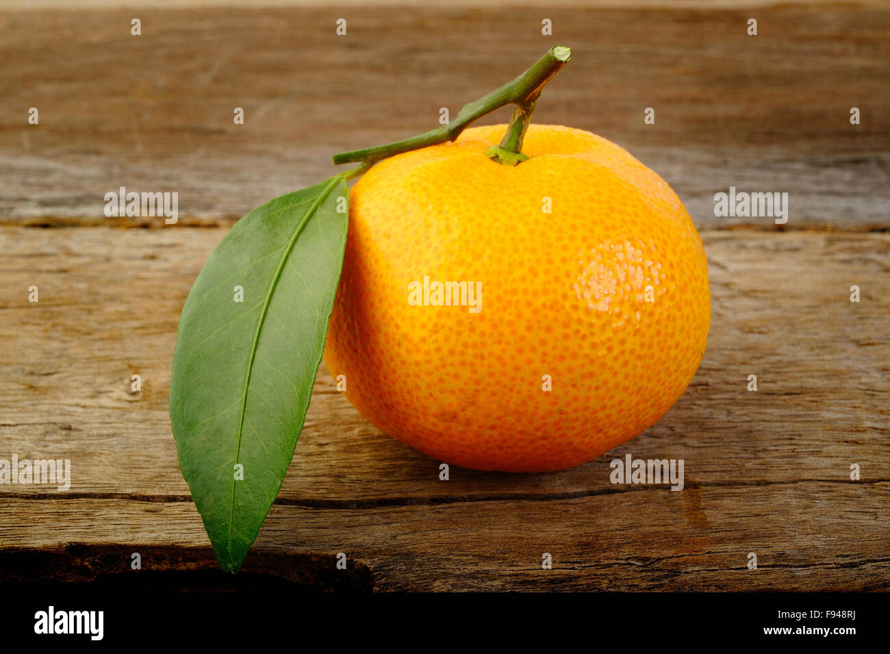 Ripe mandarin fruit on rustic wooden background Stock Photo - Alamy