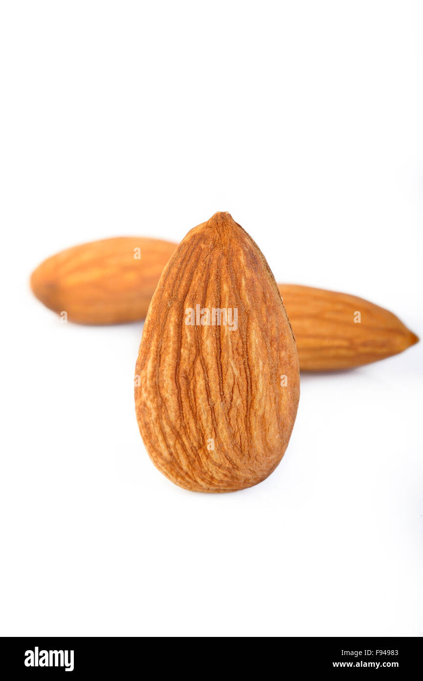 raw almond nuts isolated on white background Stock Photo - Alamy