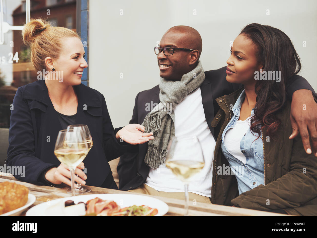 Good friends enjoying dinner outside on a cafe, ethnic friends Stock ...