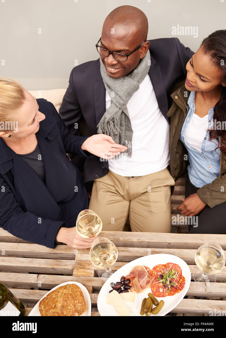 Group of friends having dinner outside, multi ethnic group Stock Photo ...