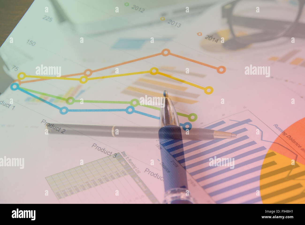 Financial graphs analysis and pen Stock Photo - Alamy