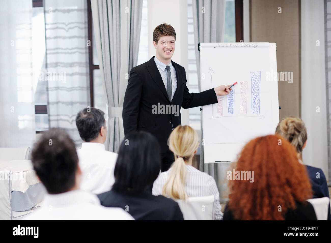 young male business man giving a presentation at a meeting seminar at ...
