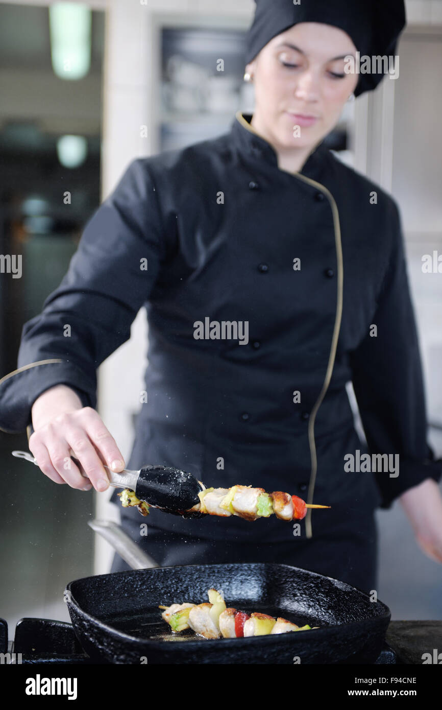 beautiful young chef woman prepare and decorating tasty food in kitchen ...