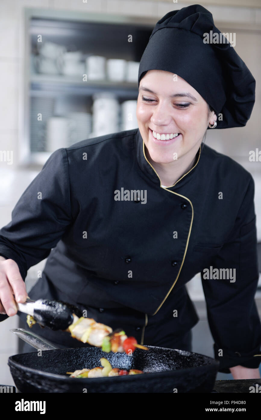 beautiful young chef woman prepare and decorating tasty food in kitchen ...