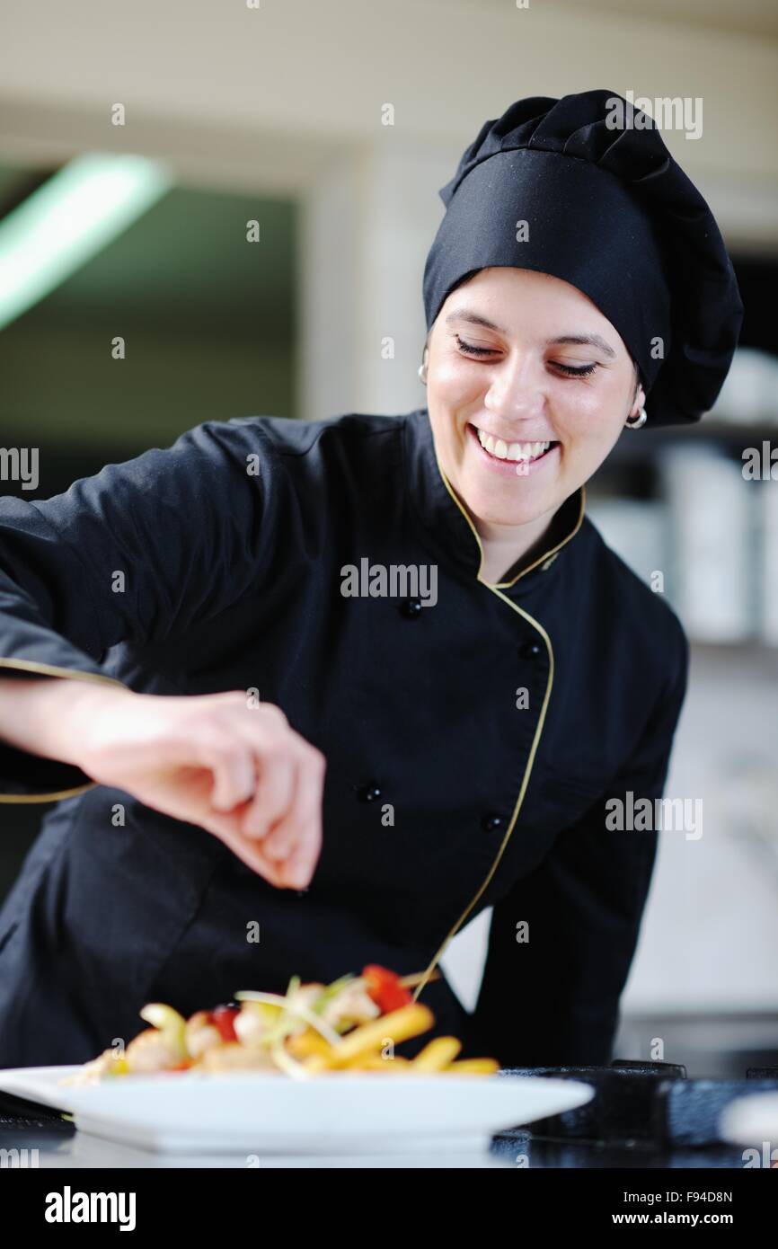 beautiful young chef woman prepare and decorating tasty food in kitchen ...