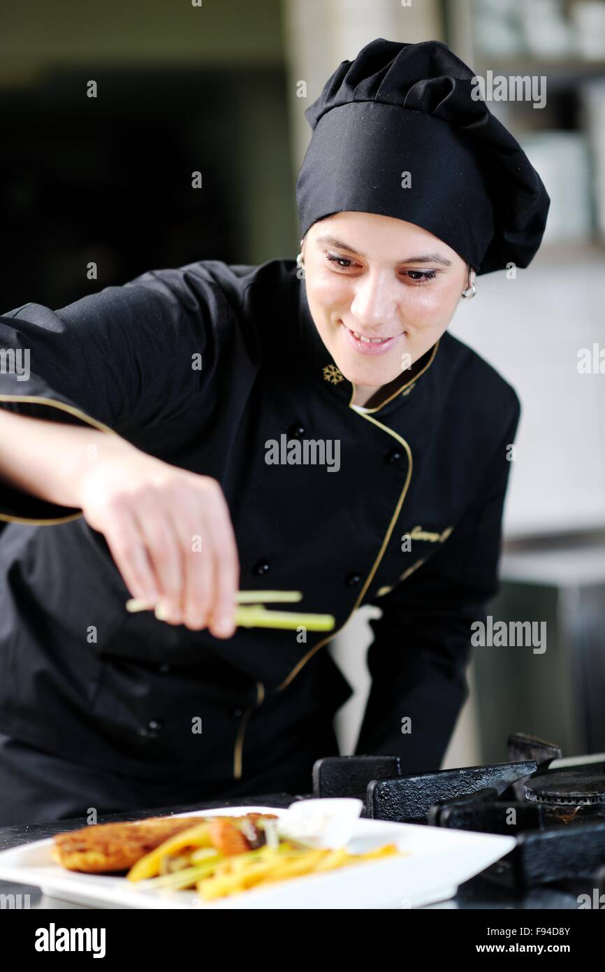 beautiful young chef woman prepare and decorating tasty food in kitchen ...
