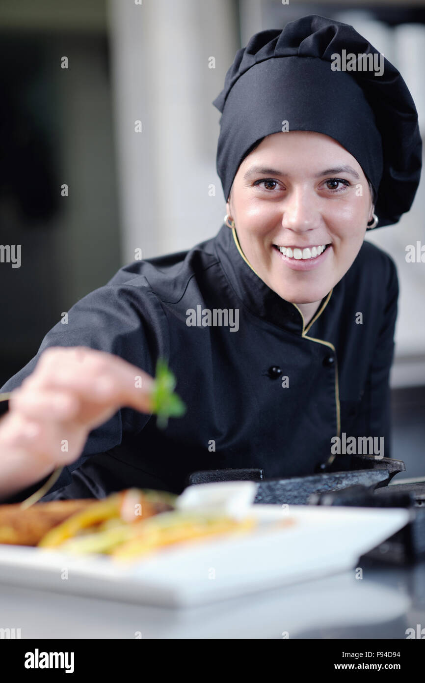 beautiful young chef woman prepare and decorating tasty food in kitchen ...