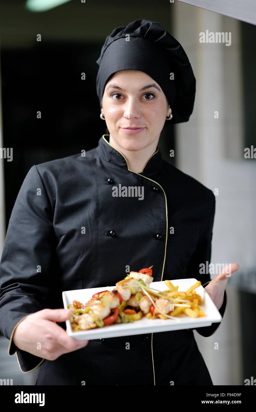 beautiful young chef woman prepare and decorating tasty food in kitchen ...
