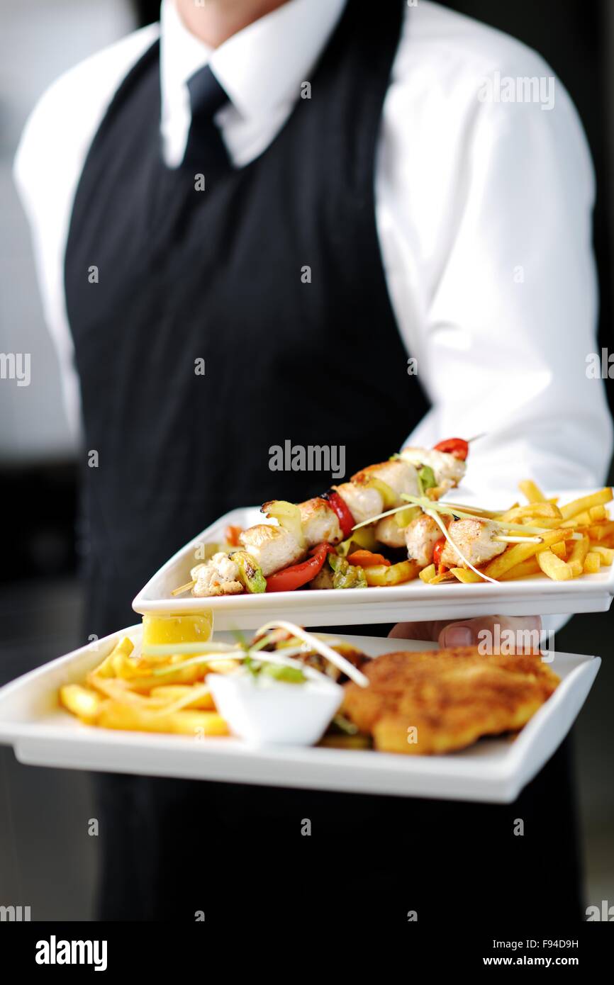 male chef presenting food meal in kitchen Stock Photo - Alamy