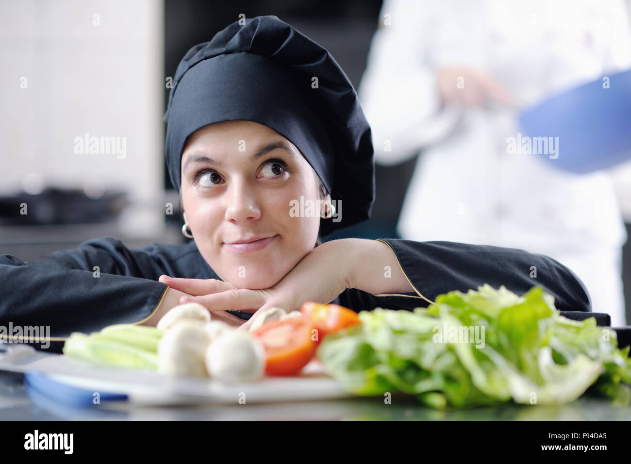 beautiful young chef woman prepare and decorating tasty food in kitchen ...
