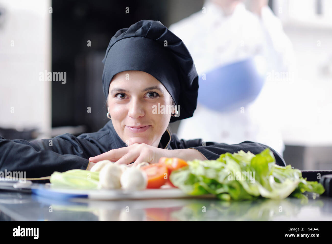 beautiful young chef woman prepare and decorating tasty food in kitchen ...