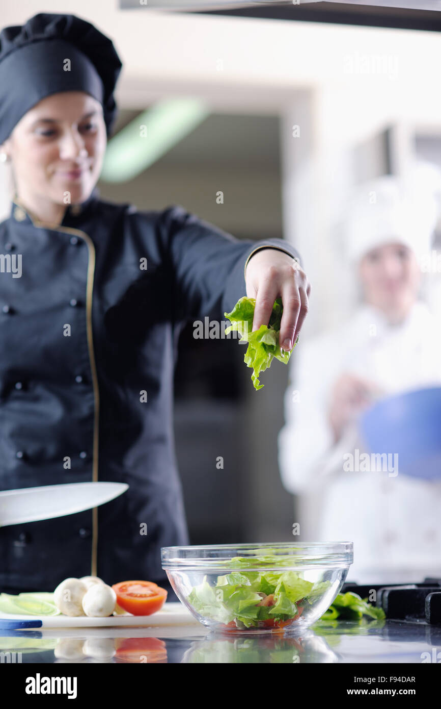 beautiful young chef woman prepare and decorating tasty food in kitchen ...