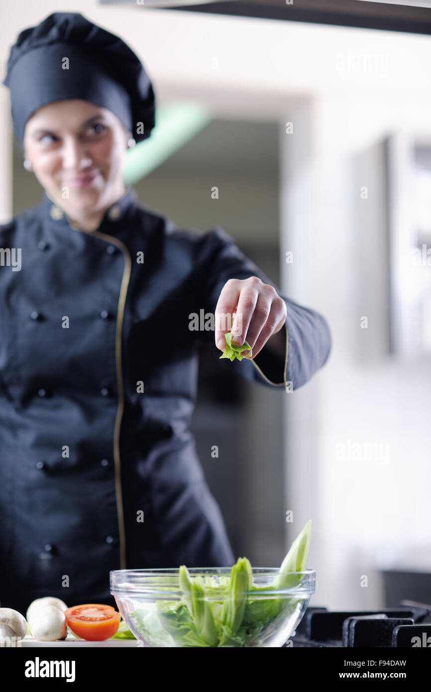 beautiful young chef woman prepare and decorating tasty food in kitchen ...