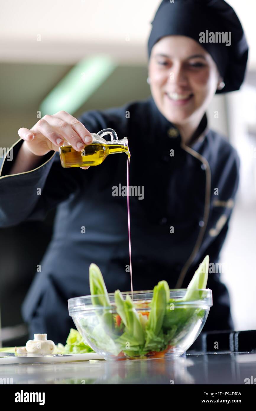 beautiful young chef woman prepare and decorating tasty food in kitchen ...