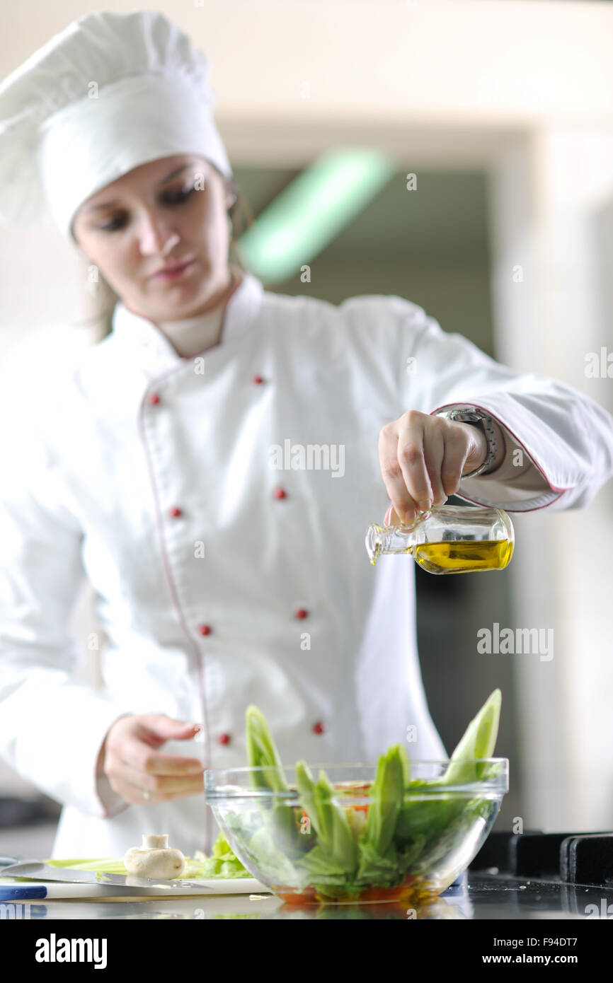 beautiful young chef woman prepare and decorating tasty food in kitchen ...