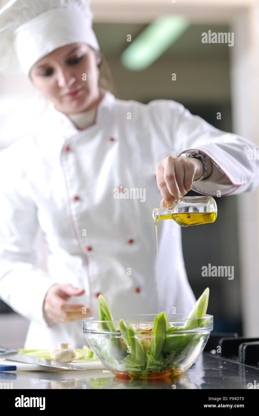beautiful young chef woman prepare and decorating tasty food in kitchen ...