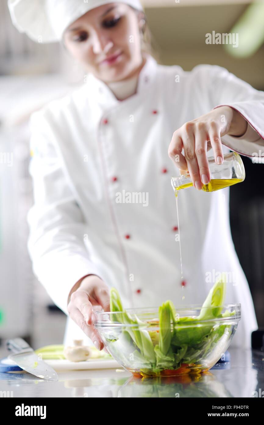 beautiful young chef woman prepare and decorating tasty food in kitchen ...