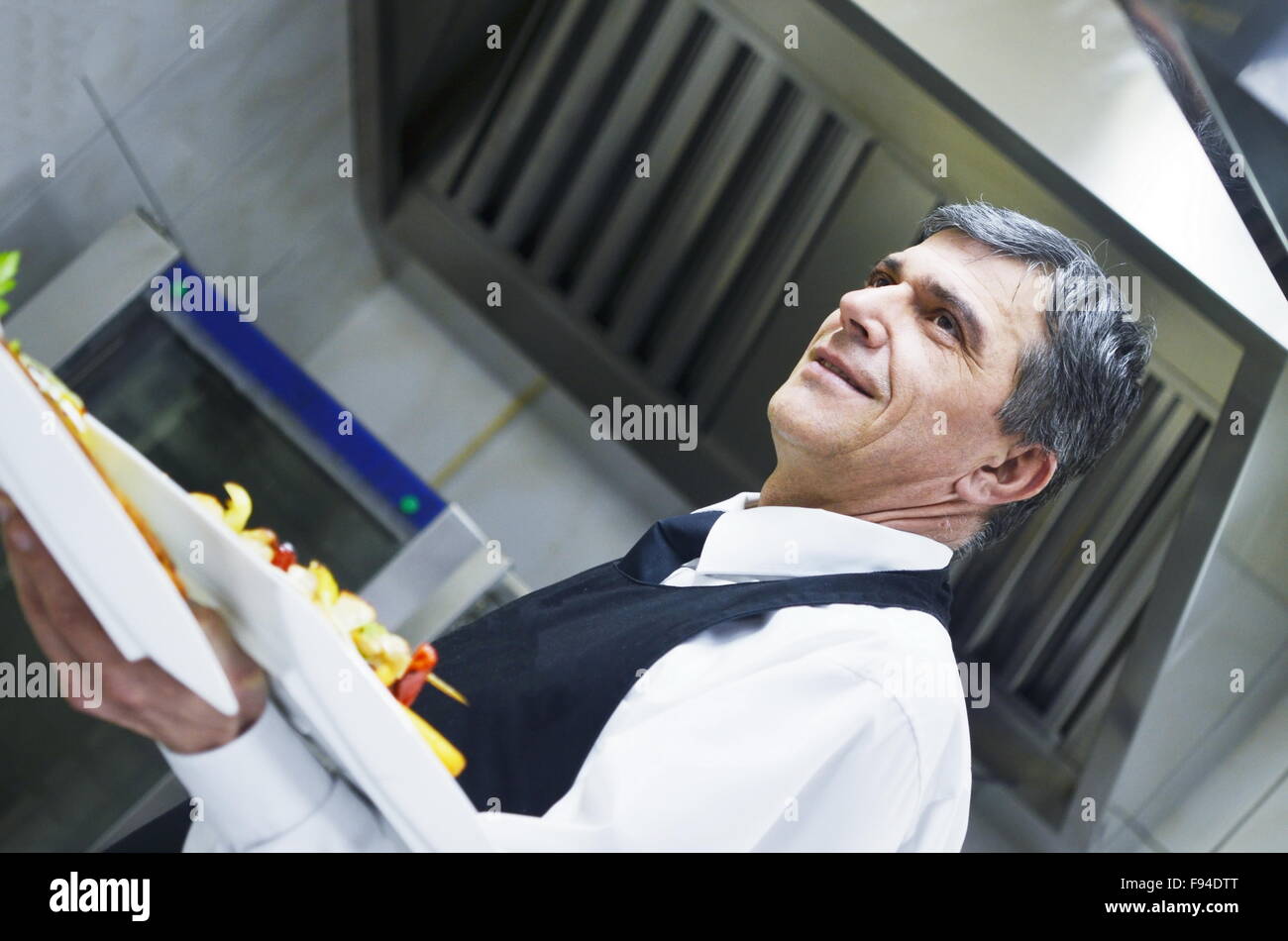 male chef presenting food meal in kitchen Stock Photo - Alamy