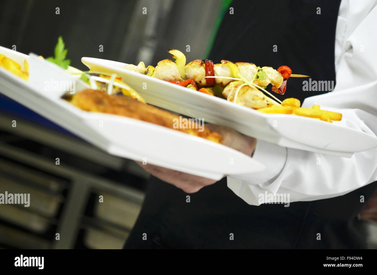 male chef presenting food meal in kitchen Stock Photo - Alamy