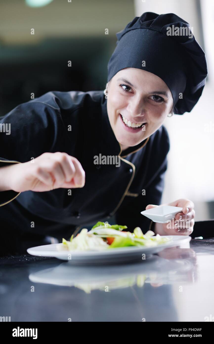 beautiful young chef woman prepare and decorating tasty food in kitchen ...