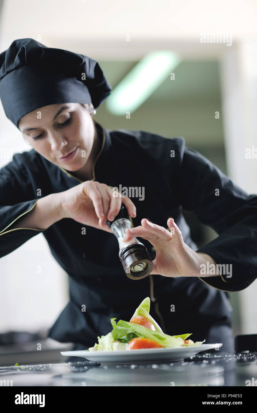 beautiful young chef woman prepare and decorating tasty food in kitchen ...