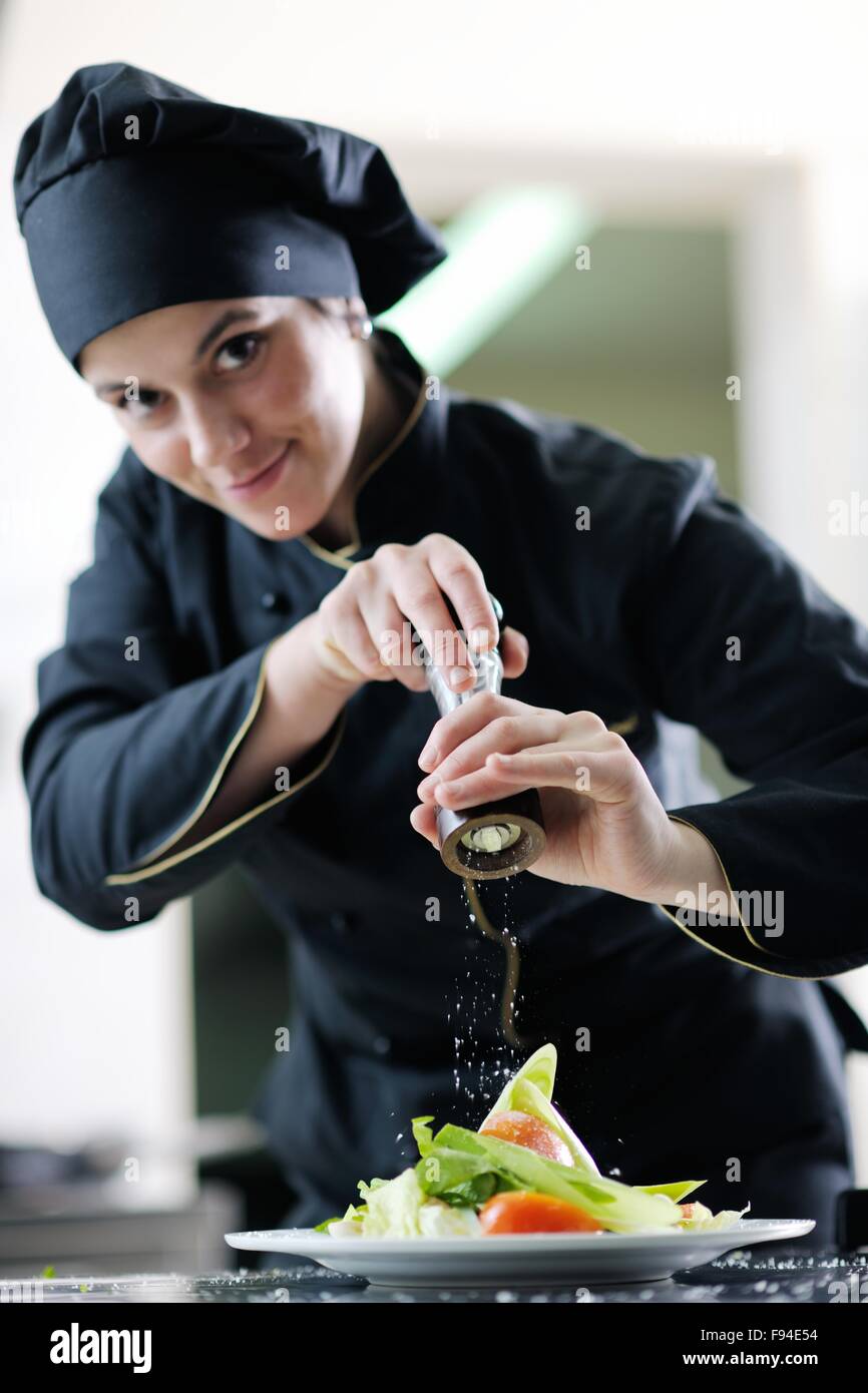 beautiful young chef woman prepare and decorating tasty food in kitchen ...