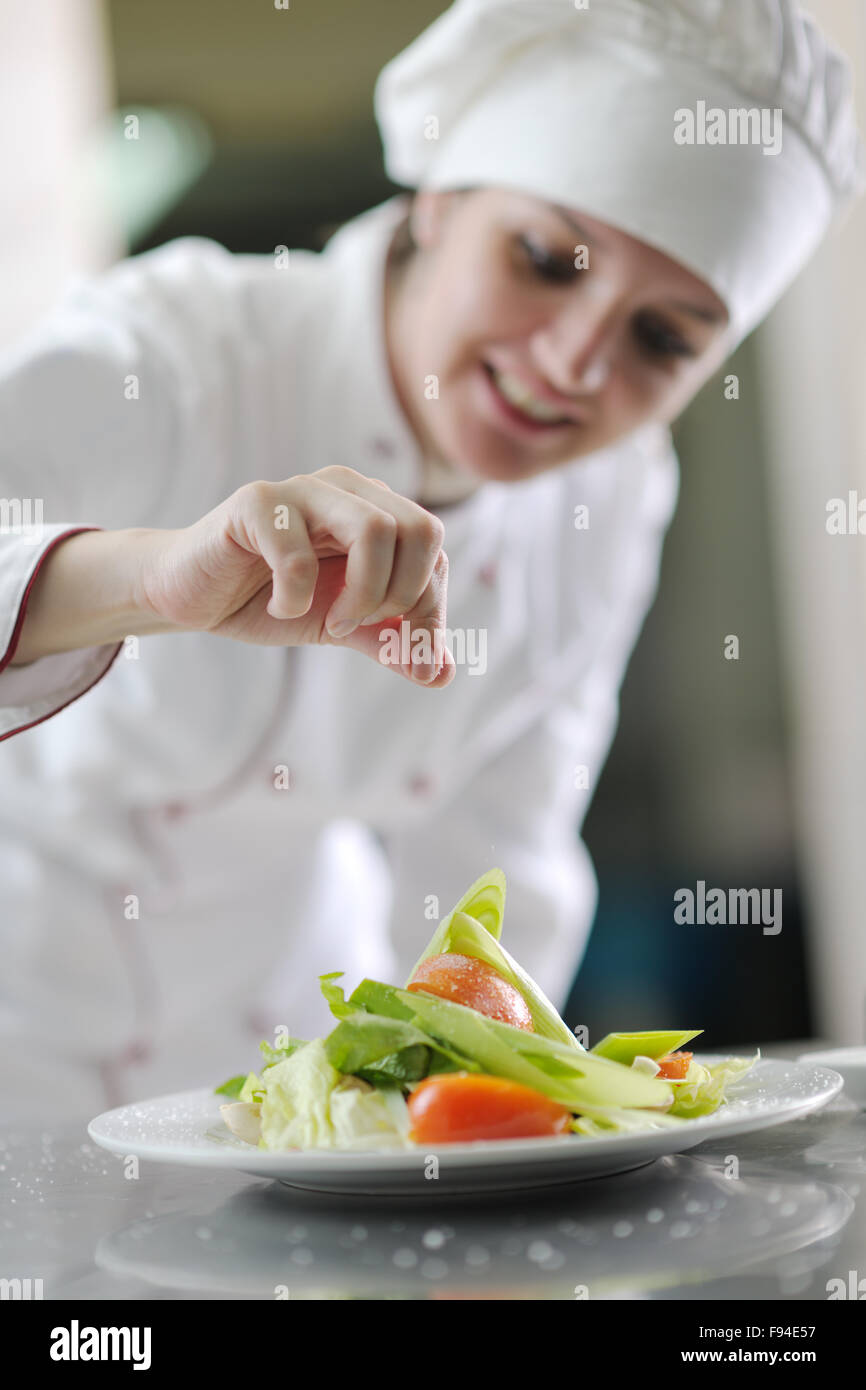 beautiful young chef woman prepare and decorating tasty food in kitchen ...