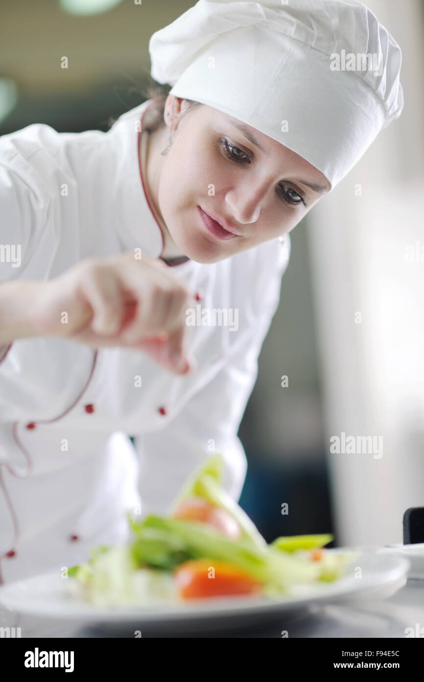 beautiful young chef woman prepare and decorating tasty food in kitchen ...