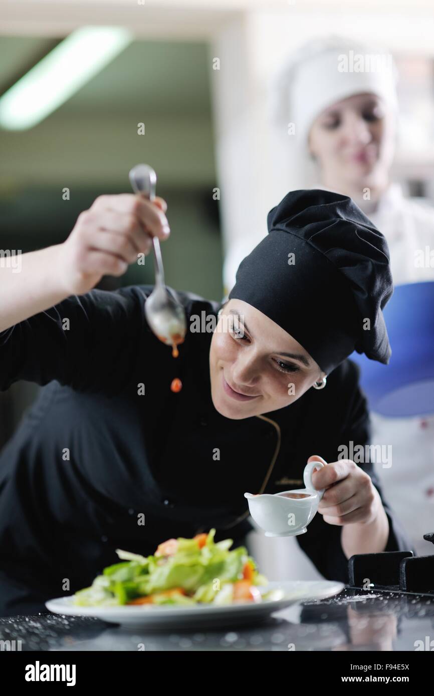 beautiful young chef woman prepare and decorating tasty food in kitchen ...