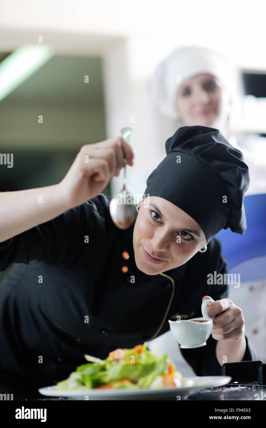 beautiful young chef woman prepare and decorating tasty food in kitchen ...