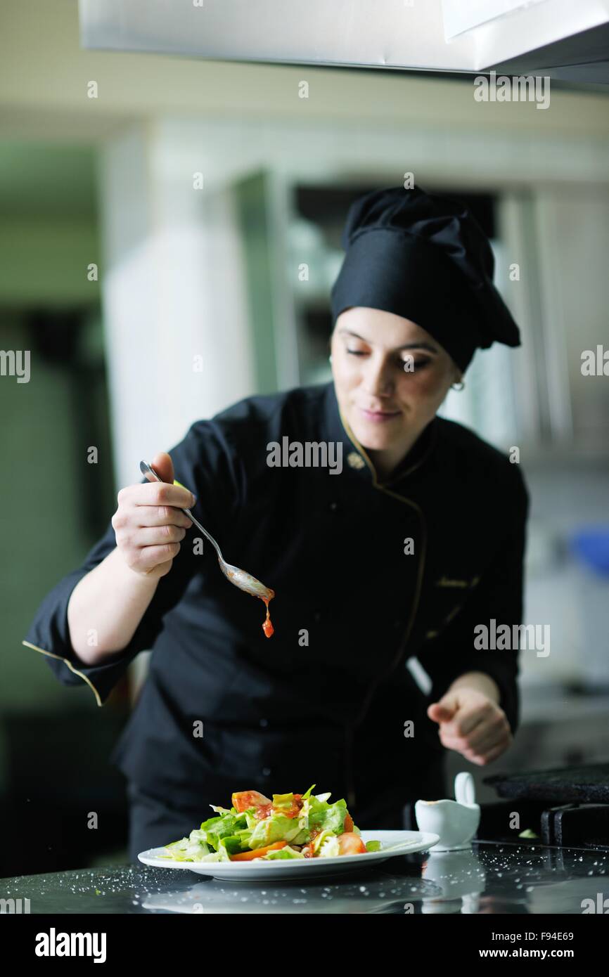 beautiful young chef woman prepare and decorating tasty food in kitchen ...
