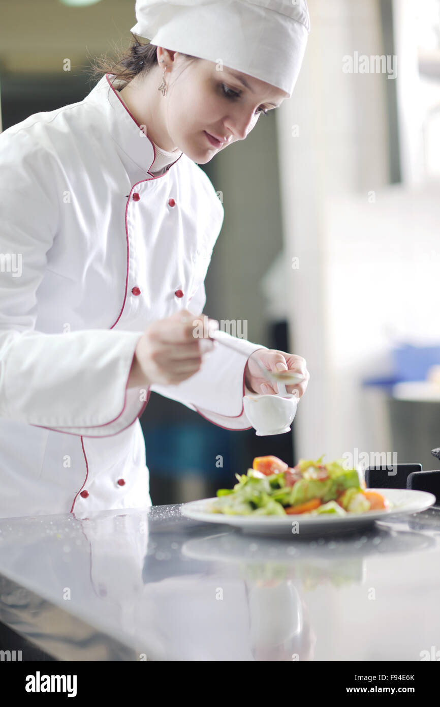 beautiful young chef woman prepare and decorating tasty food in kitchen ...