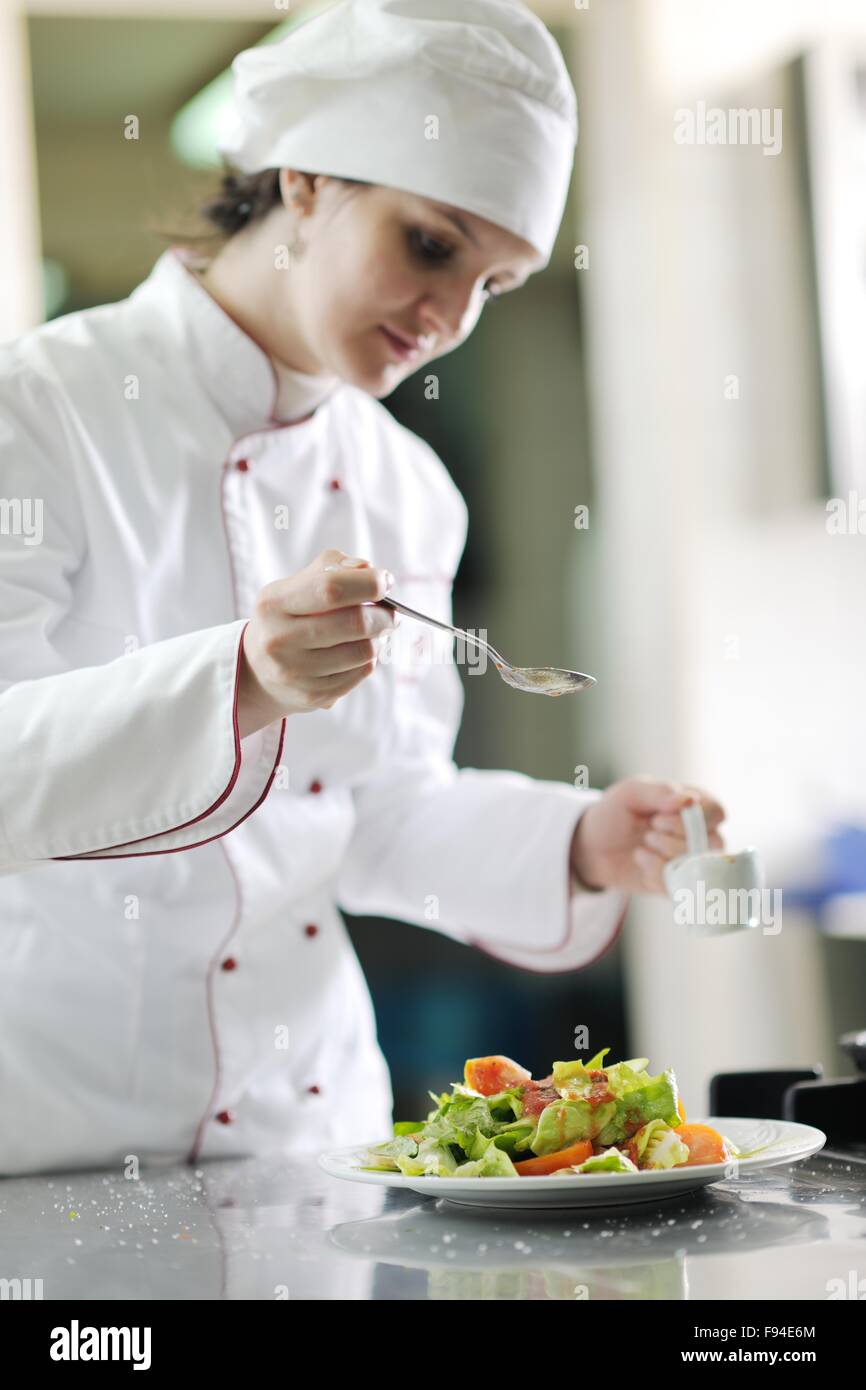 beautiful young chef woman prepare and decorating tasty food in kitchen ...