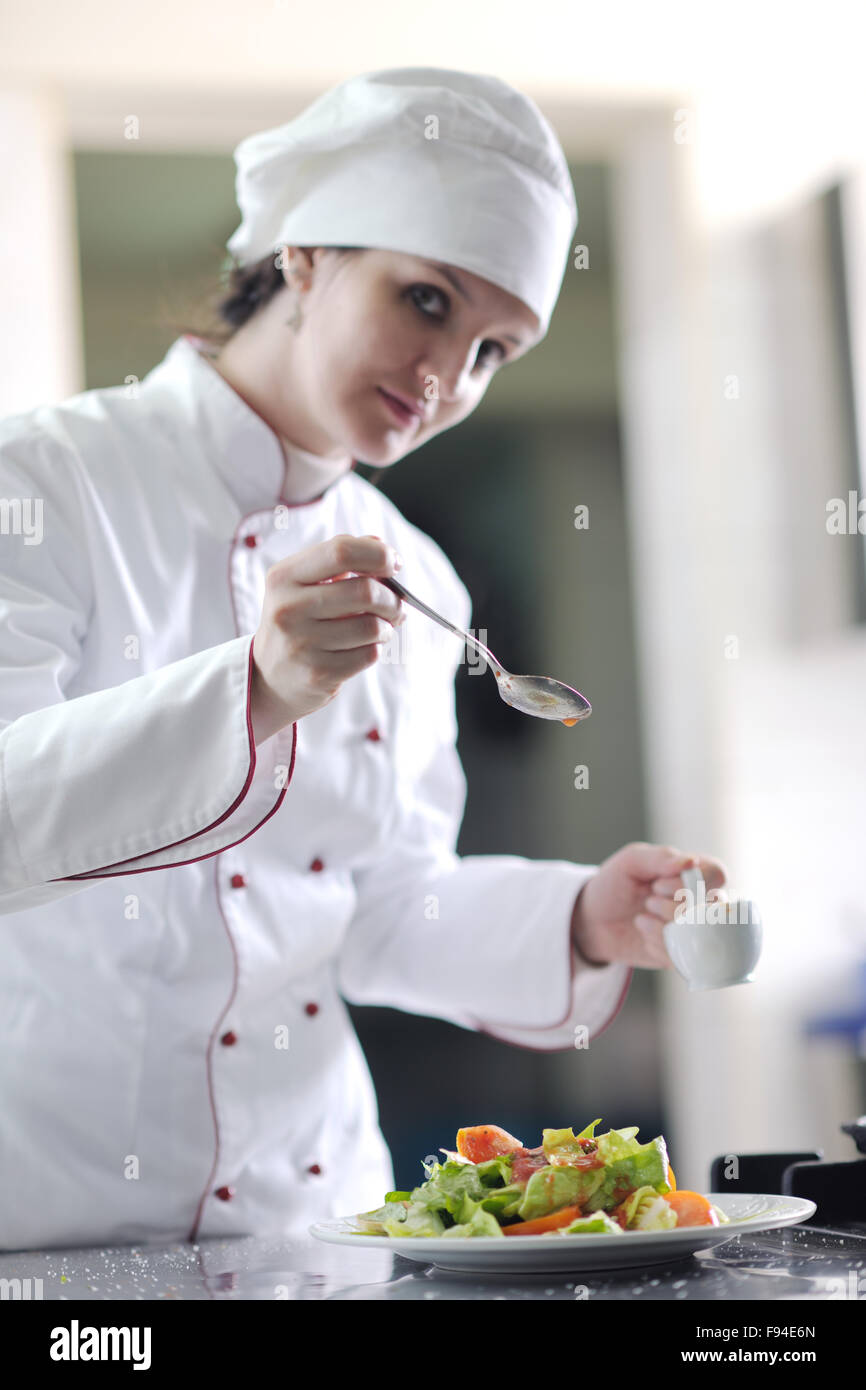 beautiful young chef woman prepare and decorating tasty food in kitchen ...