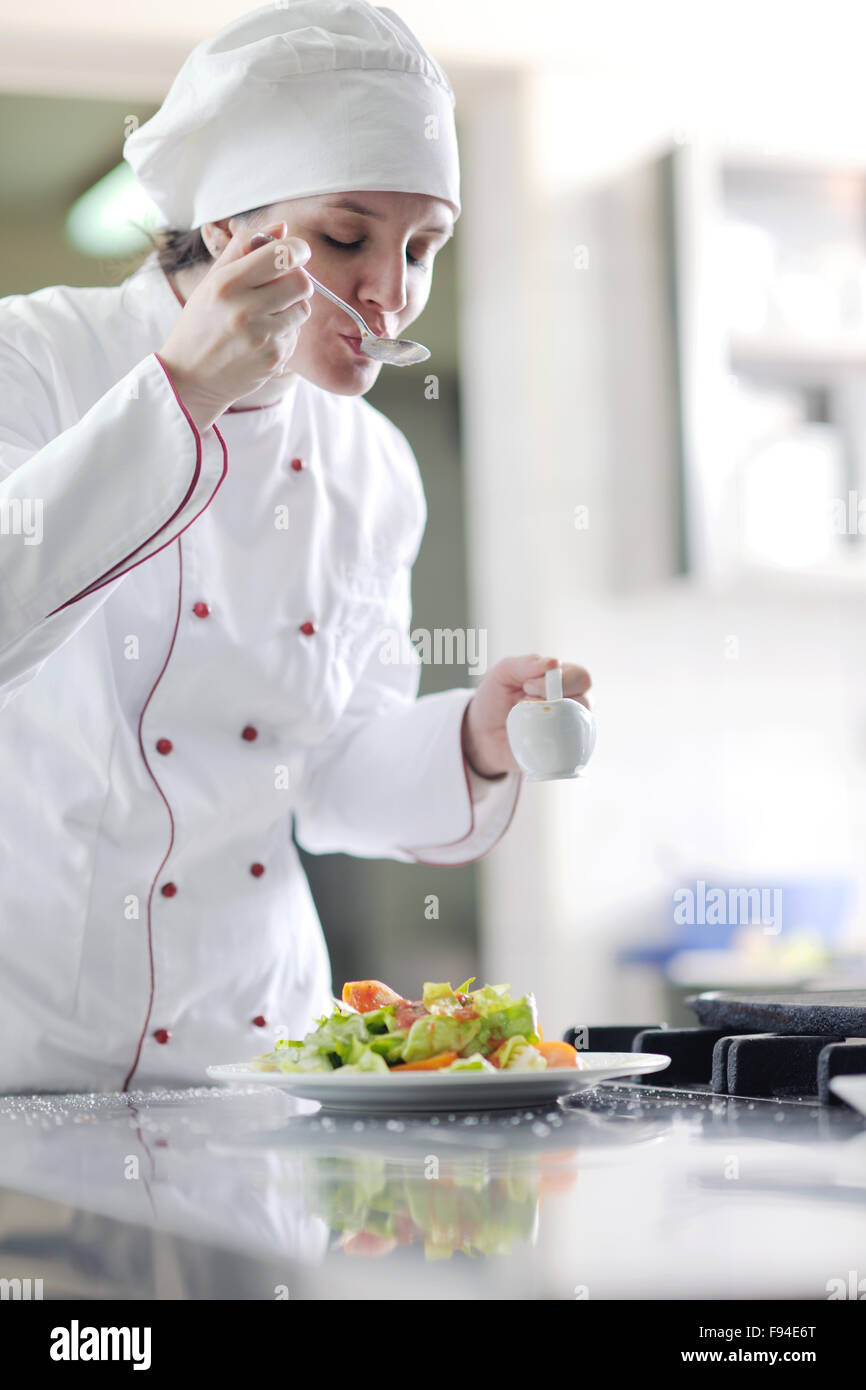 beautiful young chef woman prepare and decorating tasty food in kitchen ...