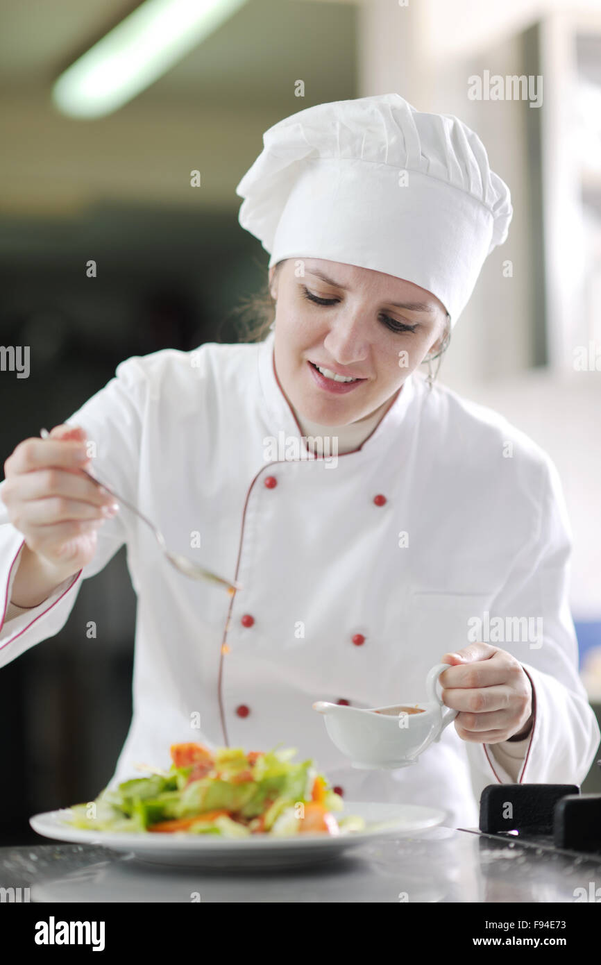 beautiful young chef woman prepare and decorating tasty food in kitchen ...
