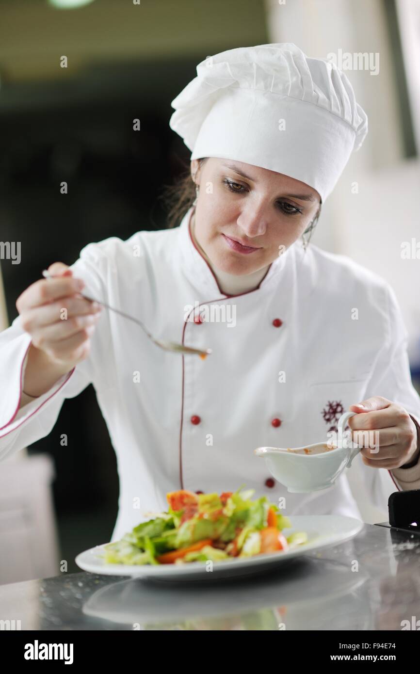 beautiful young chef woman prepare and decorating tasty food in kitchen ...