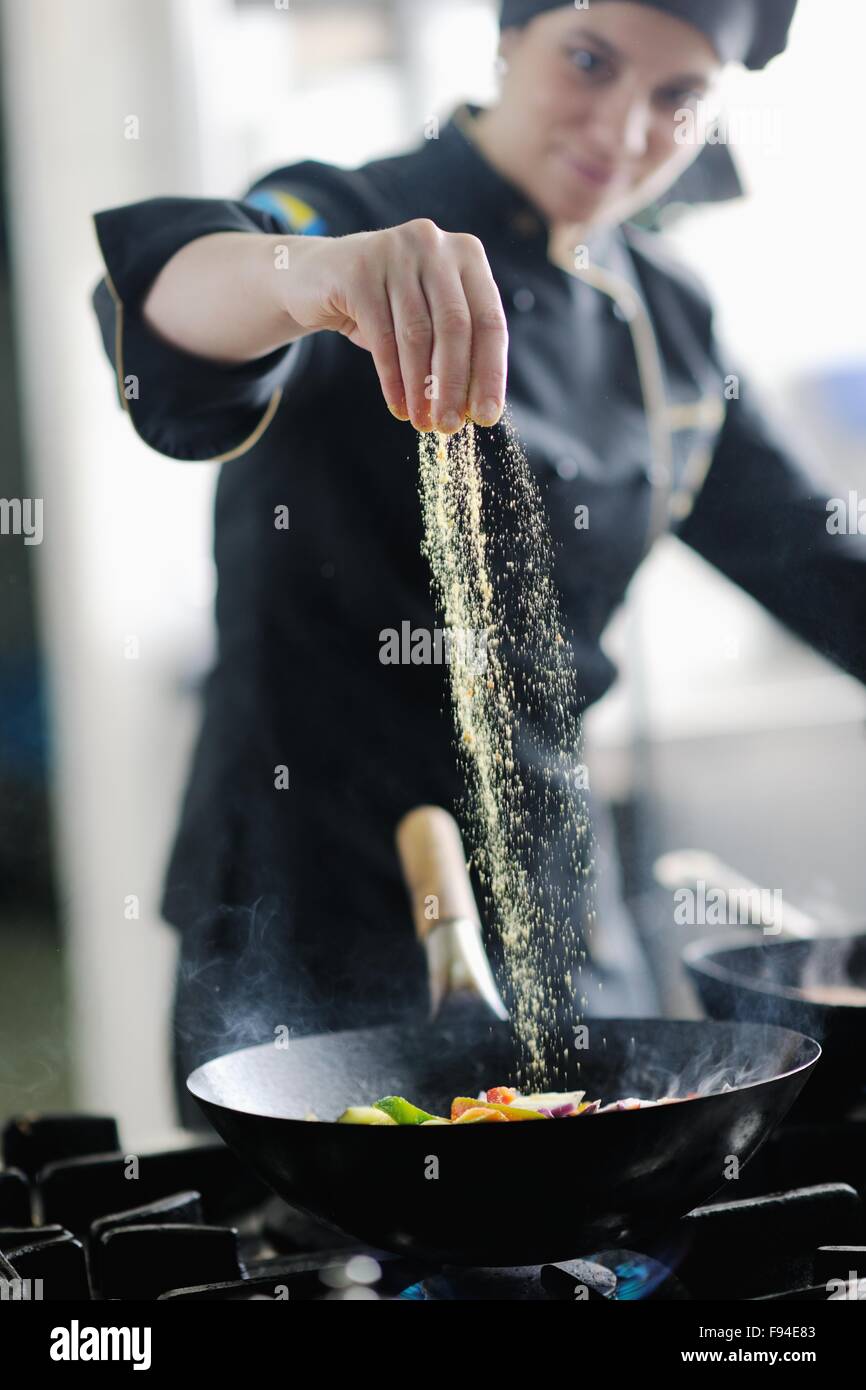 beautiful young chef woman prepare and decorating tasty food in kitchen ...