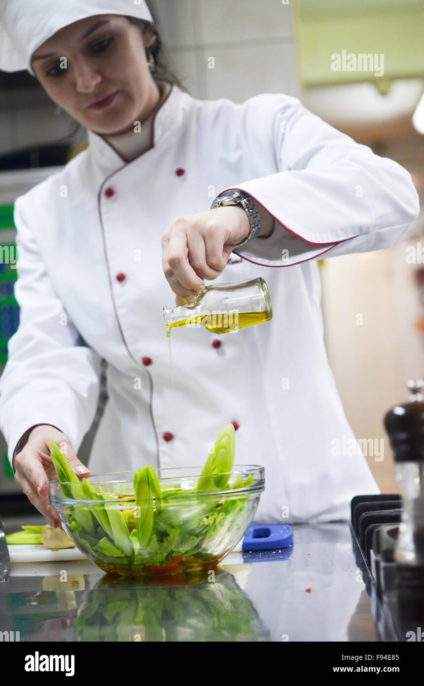 beautiful young chef woman prepare and decorating tasty food in kitchen ...