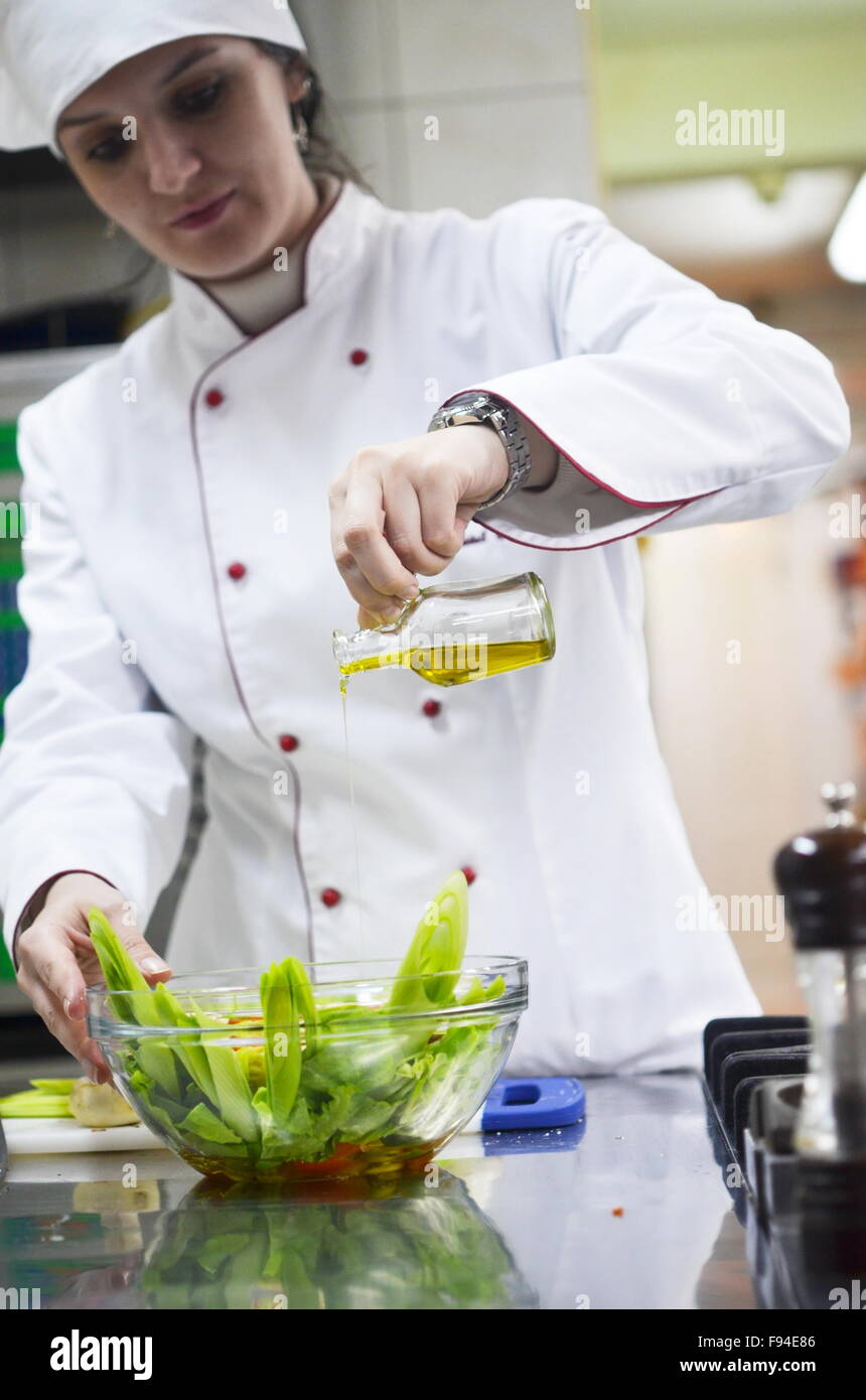 beautiful young chef woman prepare and decorating tasty food in kitchen ...